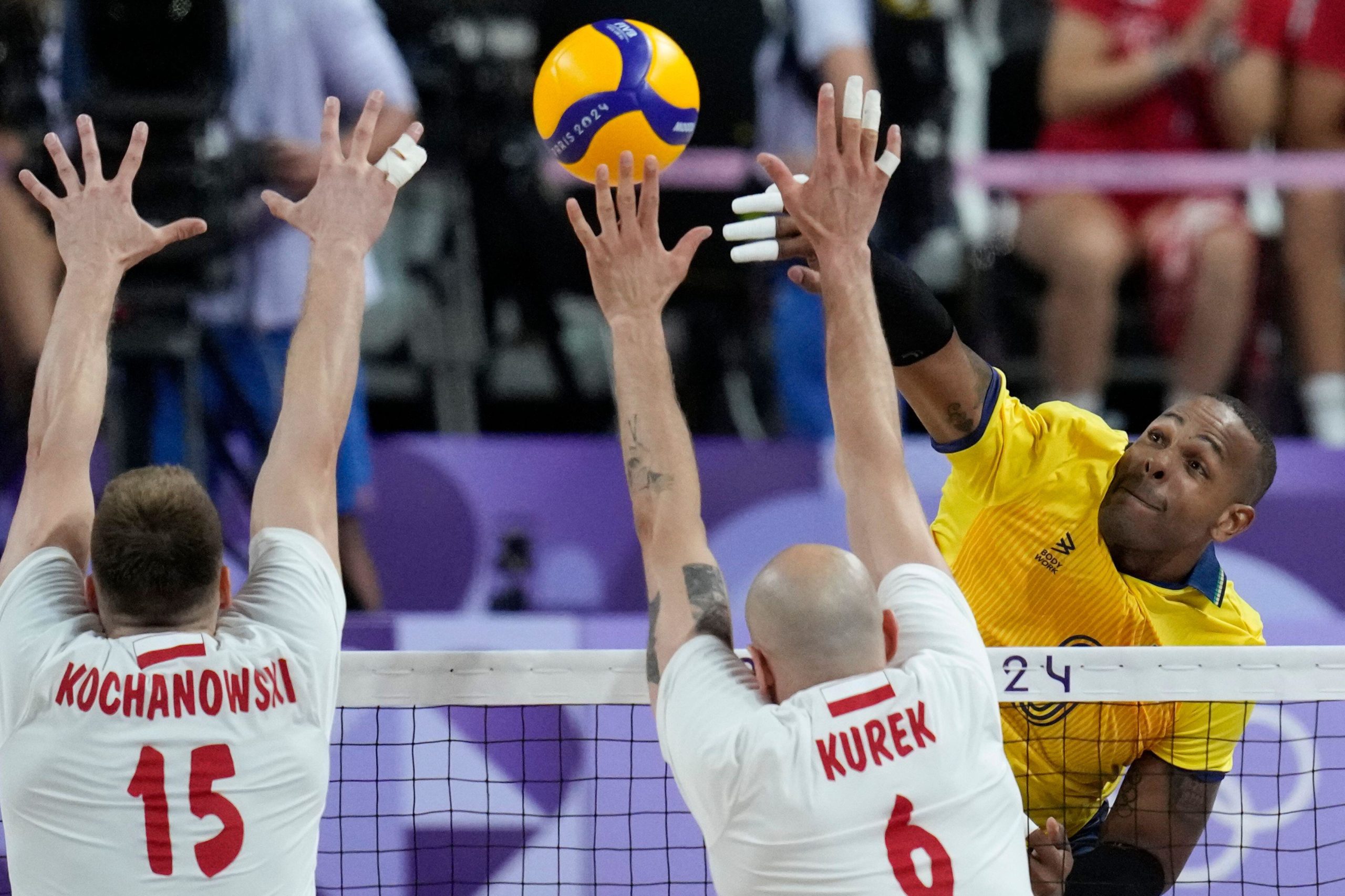 Yoandy Leal Hidalgo, of Brazil, right spikes the ball against Poland ...